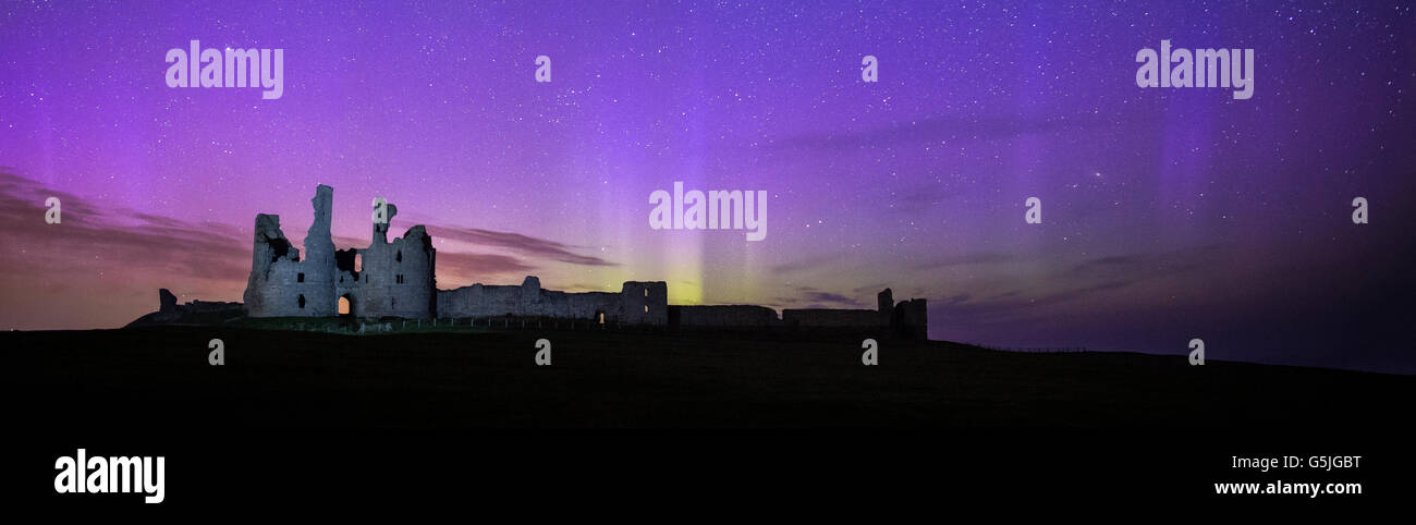 The Northern Lights Behind Dunstanburgh Castle, Northumberland Stock ...