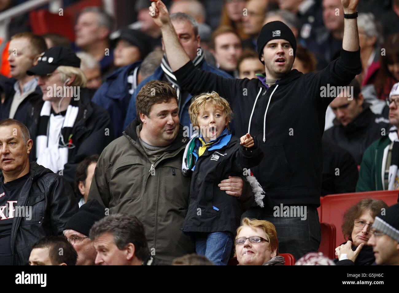 A young fulham fan with his father in the stands hi-res stock ...