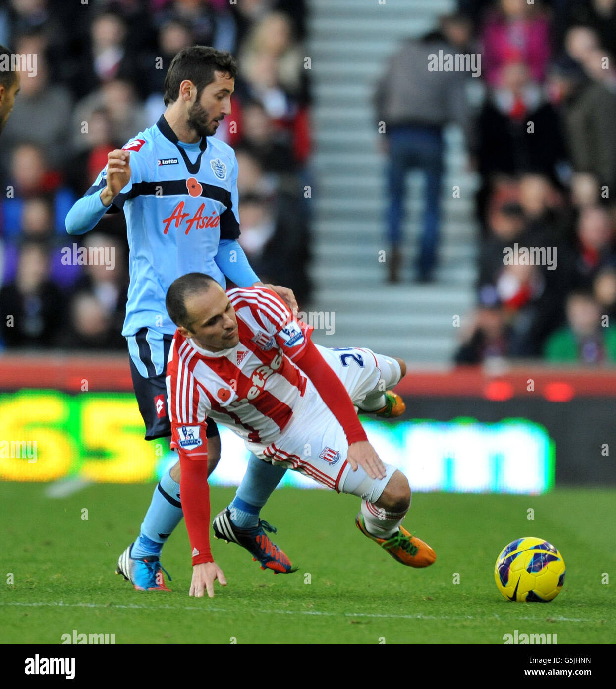 Stoke City's Matthew Etherington is fouled by Queens Park Rangers ...