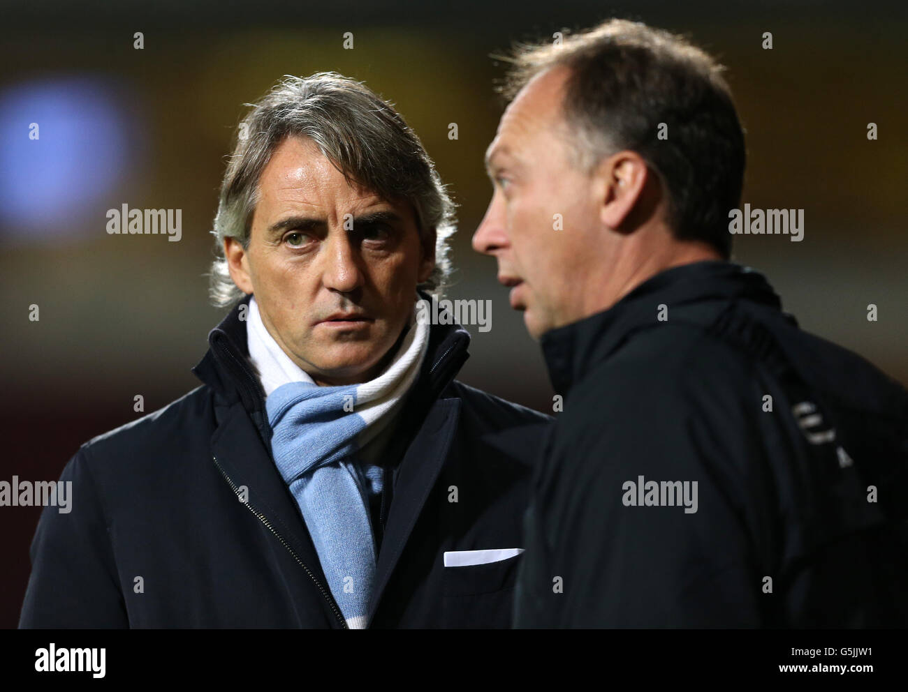 Manchester City's manager Roberto Mancini (left) and first team coach ...