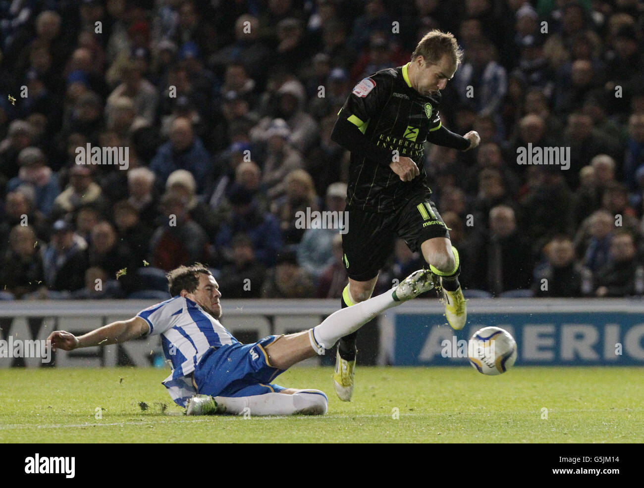 Brighton's Gordon Greer challenges Leeds United's Luke Varney (right ...