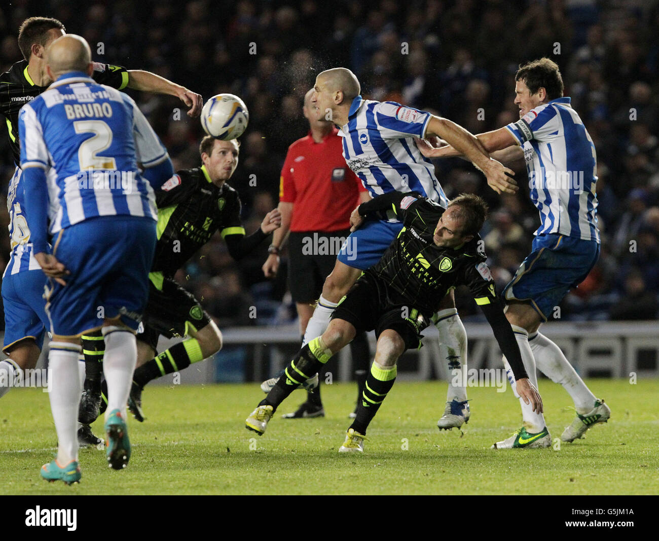 Brighton's Adam El-Abd (centre) is challenged by Leeds United's Luke ...