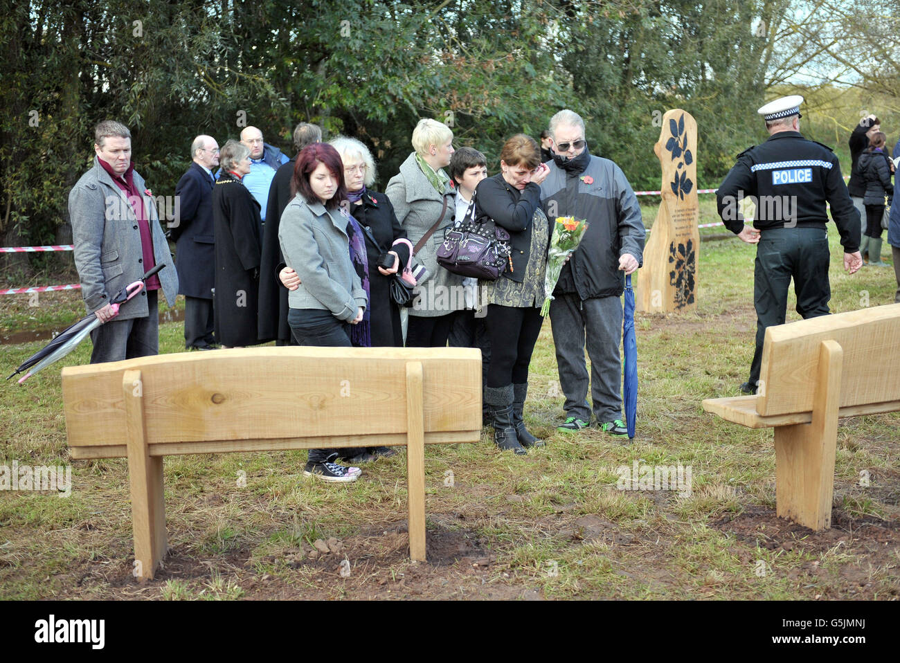 Tonia White prepares to place flowers on benches dedicated to her ...