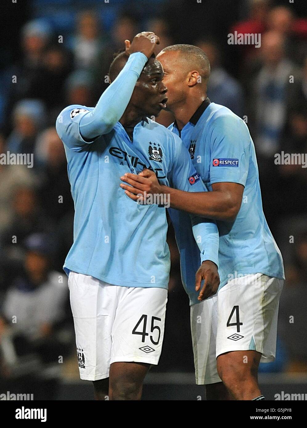 Manchester City's Mario Balotelli (left) has to be led away by teammate ...