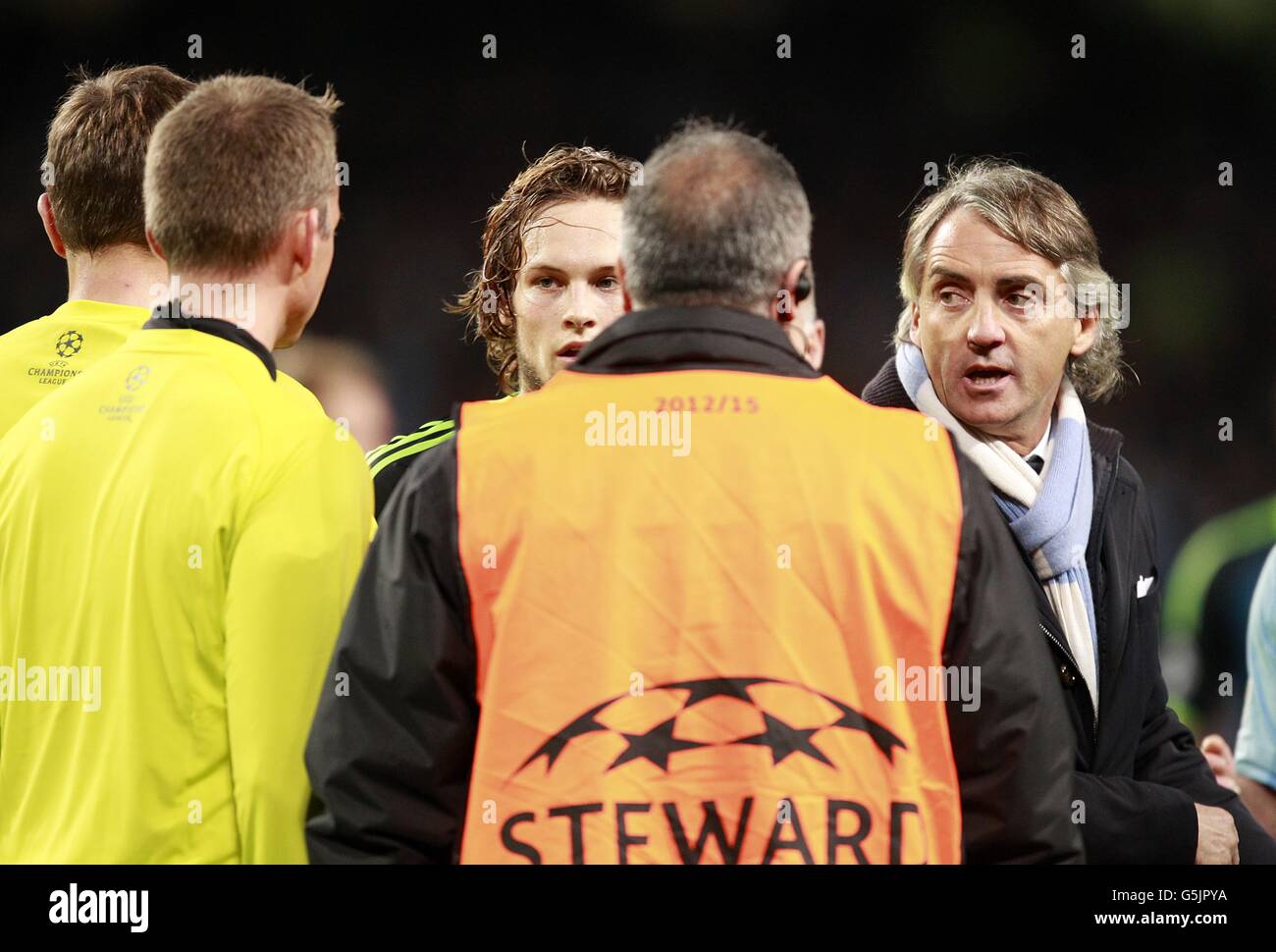 Manchester City manager Roberto Mancini (right) complains to referee ...