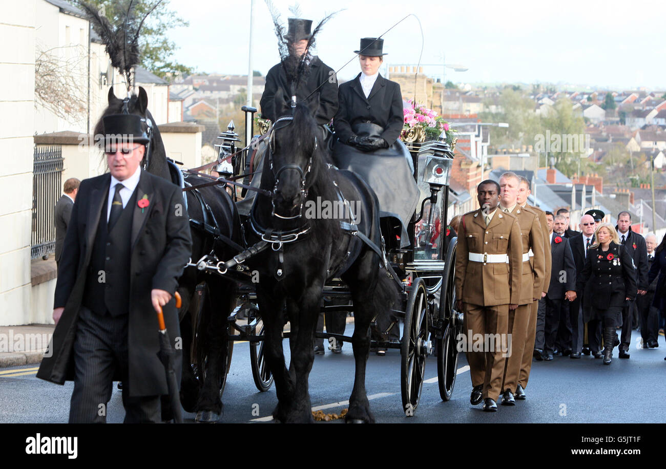 A horse drawn carriage carries the coffin of Corporal Channing Day, who ...