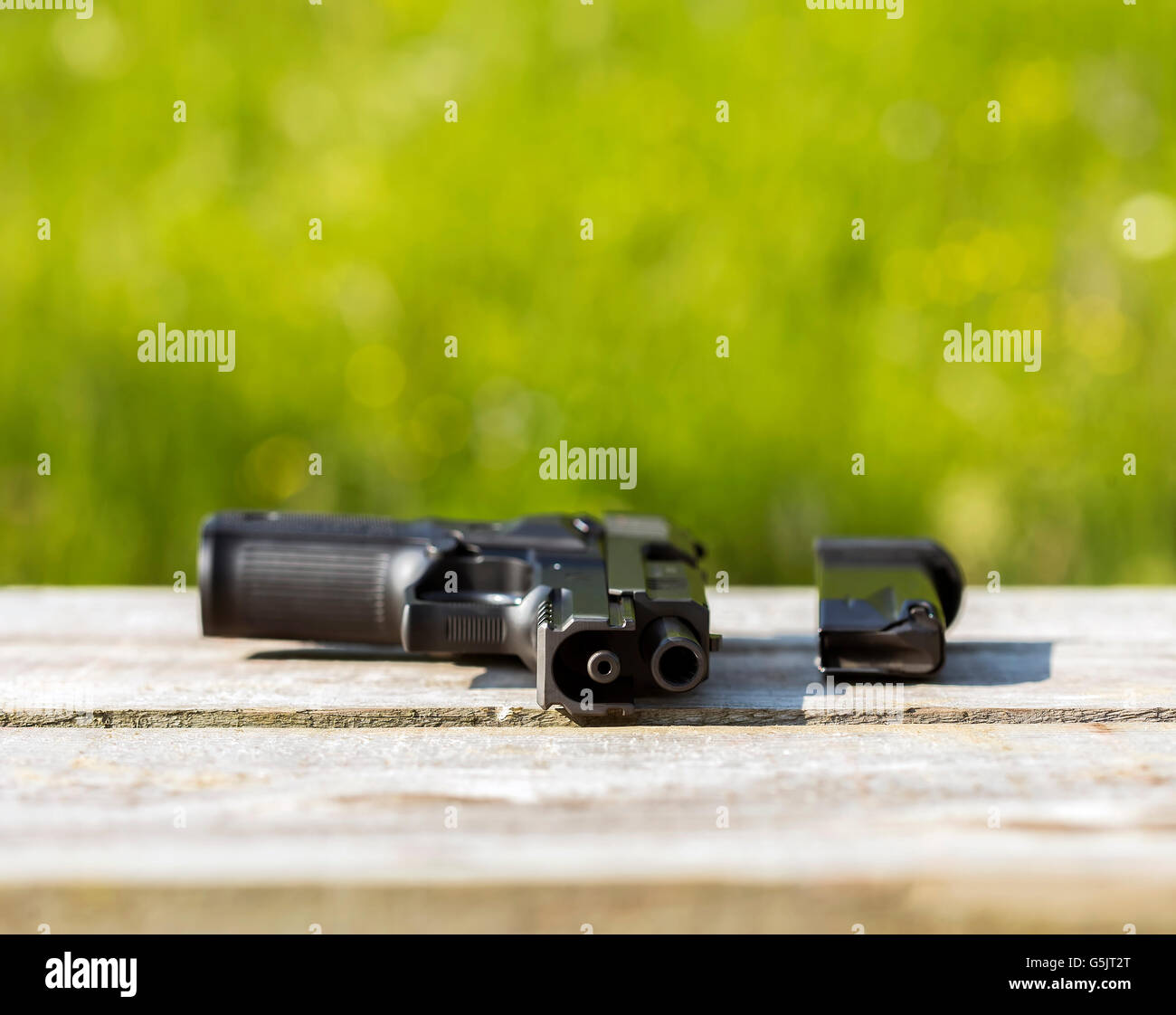 Gun with a clip with a blurred background Stock Photo - Alamy