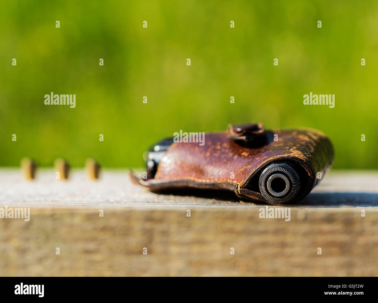 Gun with bullets, with a blurred background Stock Photo - Alamy