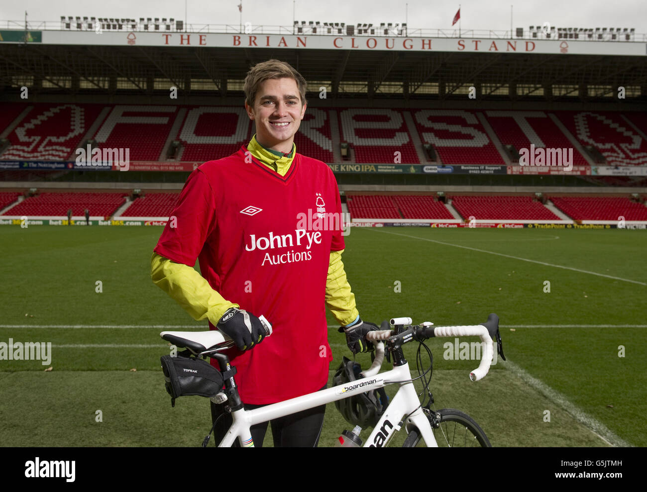 Cyclist Rowan Staszkiewicz poses pitchside before his 26 mile bike ride ...
