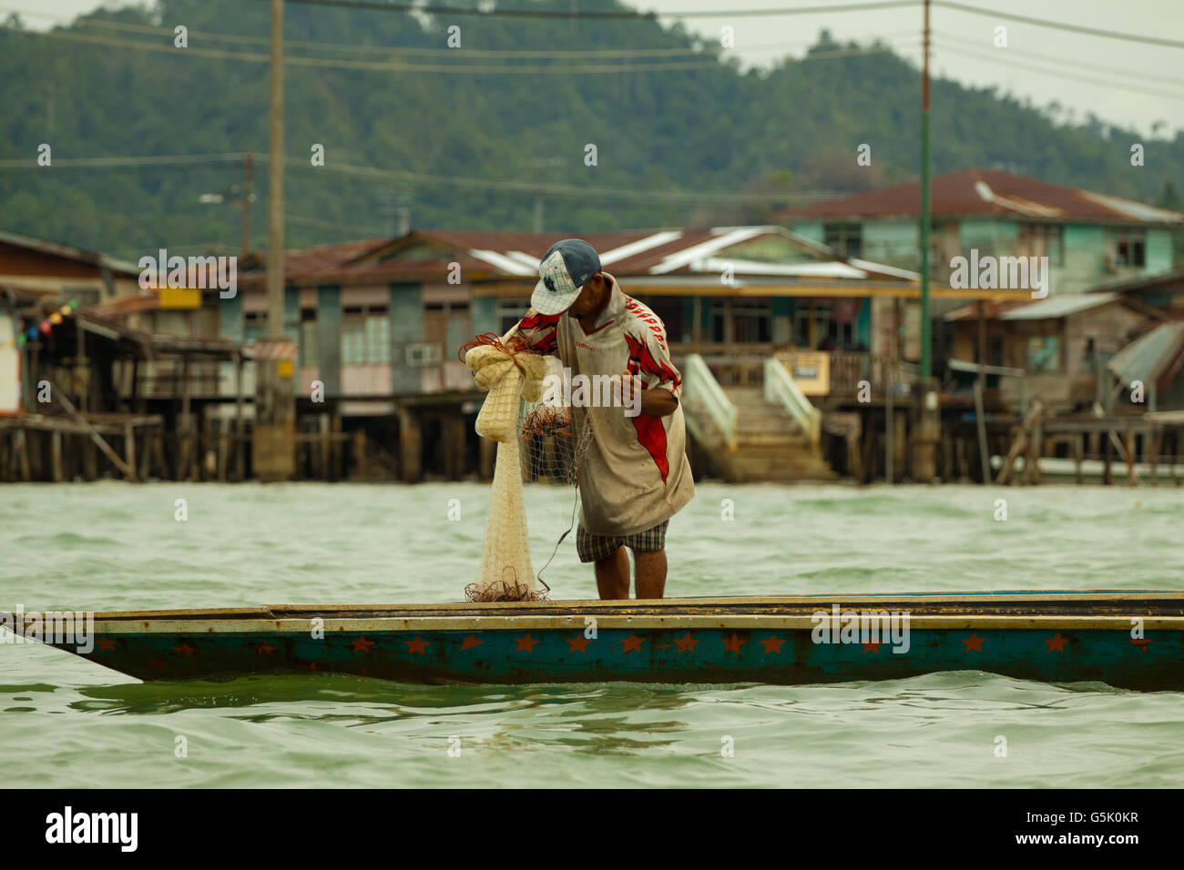 Fisherman fishing in the sea, Kampong Ayer, Brunei Stock Photo - Alamy
