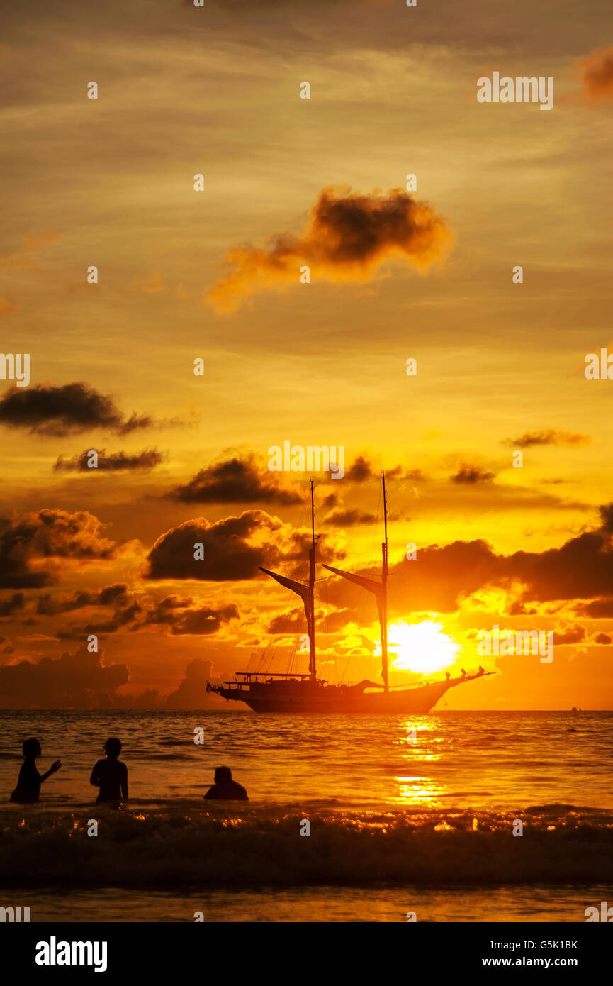 Dramatic sea and transport boat in color of sunset with over light the ...