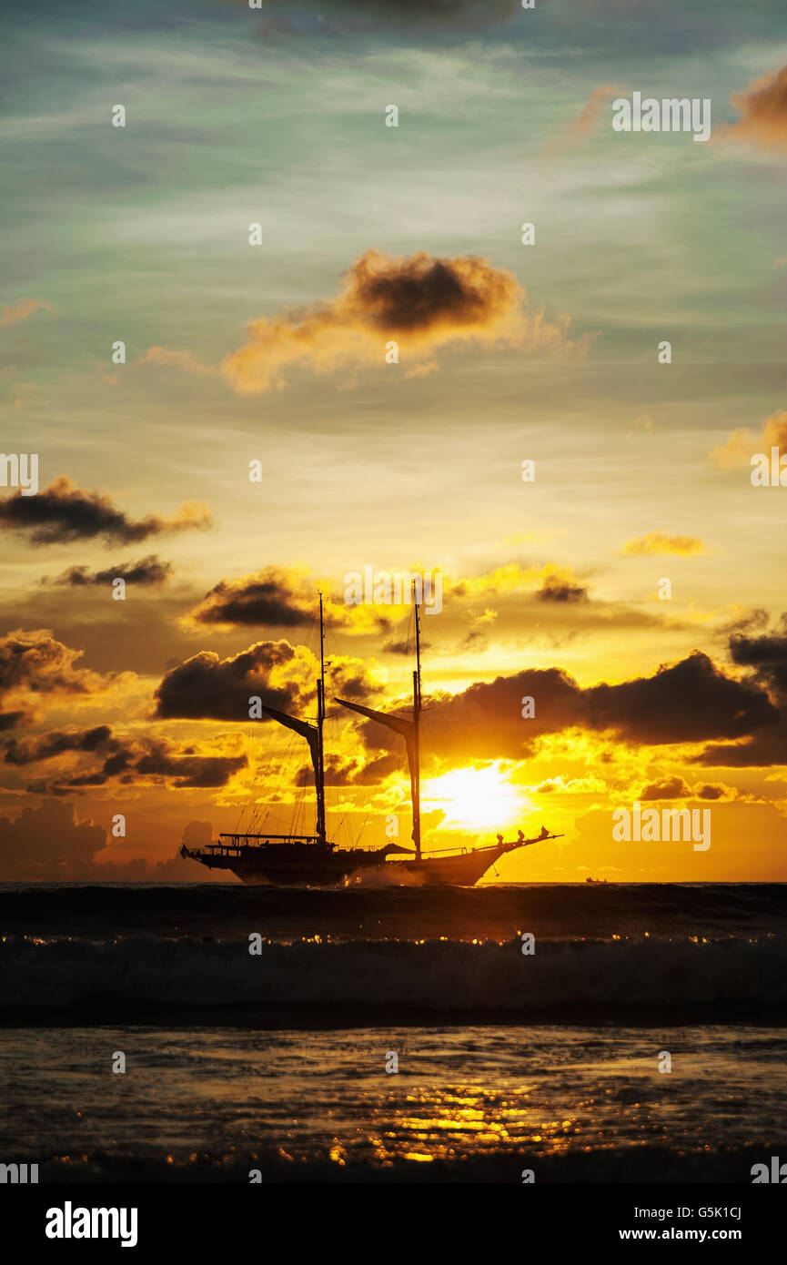 Dramatic sea and transport boat in color of sunset with over light the ...