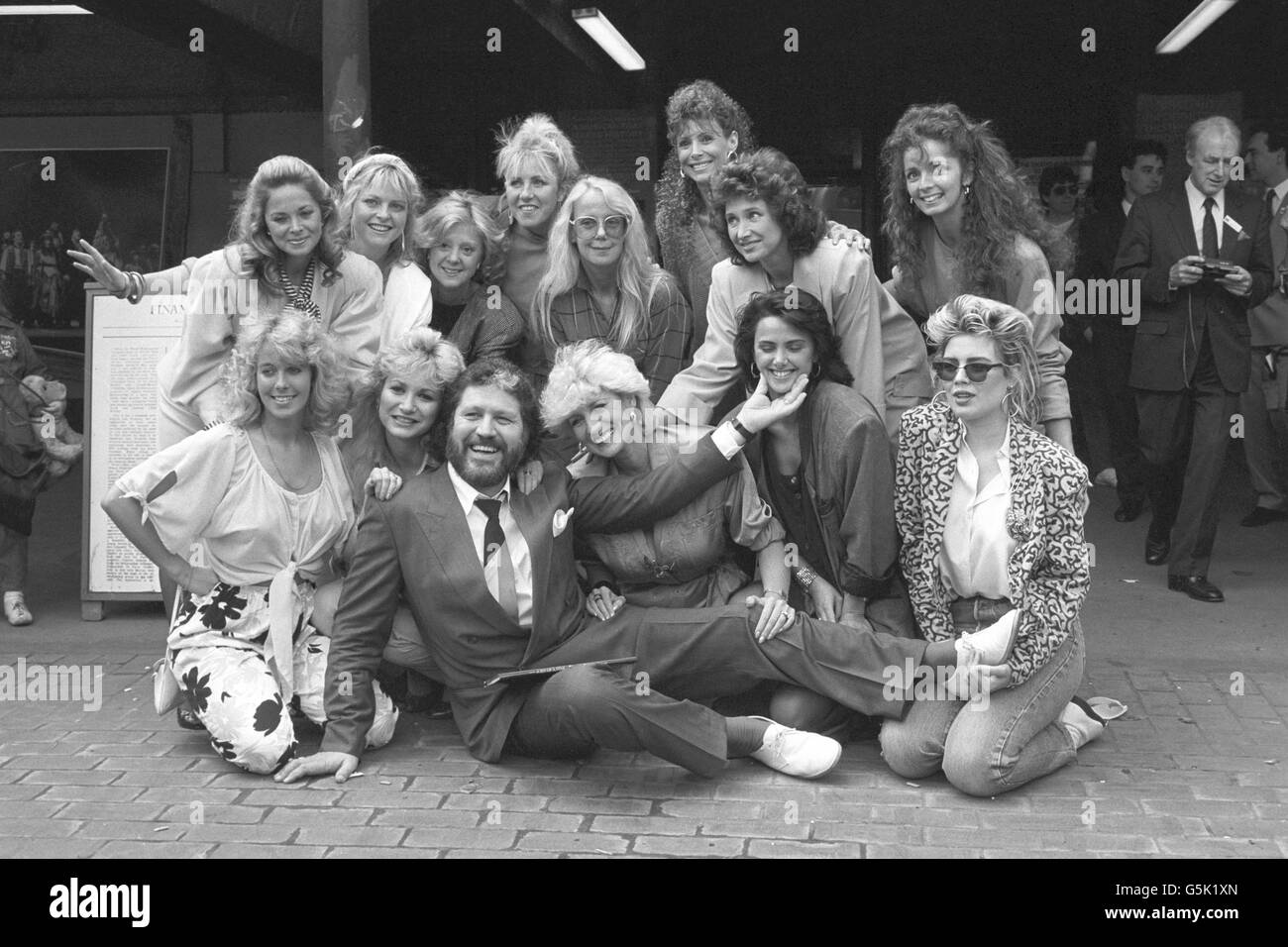 DJ Dave Lee Travis is surrounded by some of the women who appear in his ...
