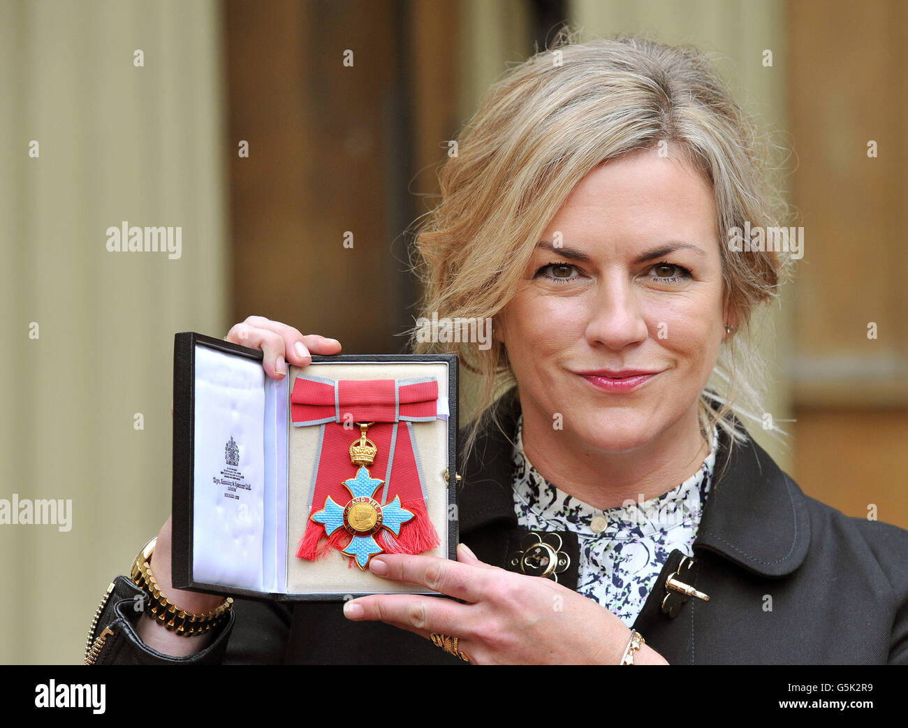 Emma Hill proudly holds her Commander of the British Empire (CBE) after ...