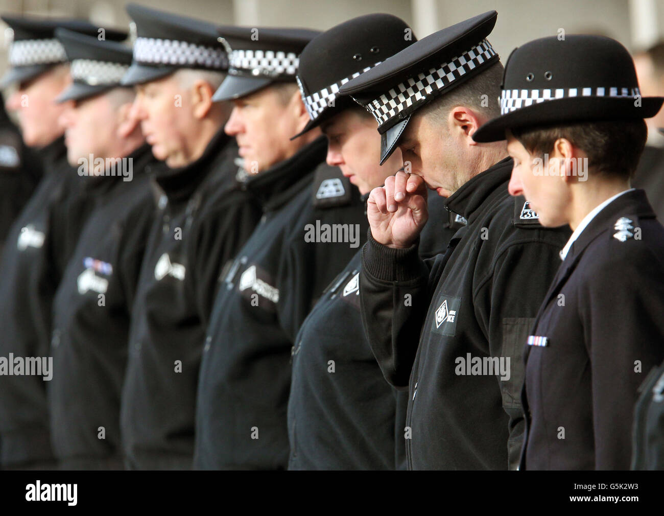 Police officers line up to show their respect as the cortege carrying ...
