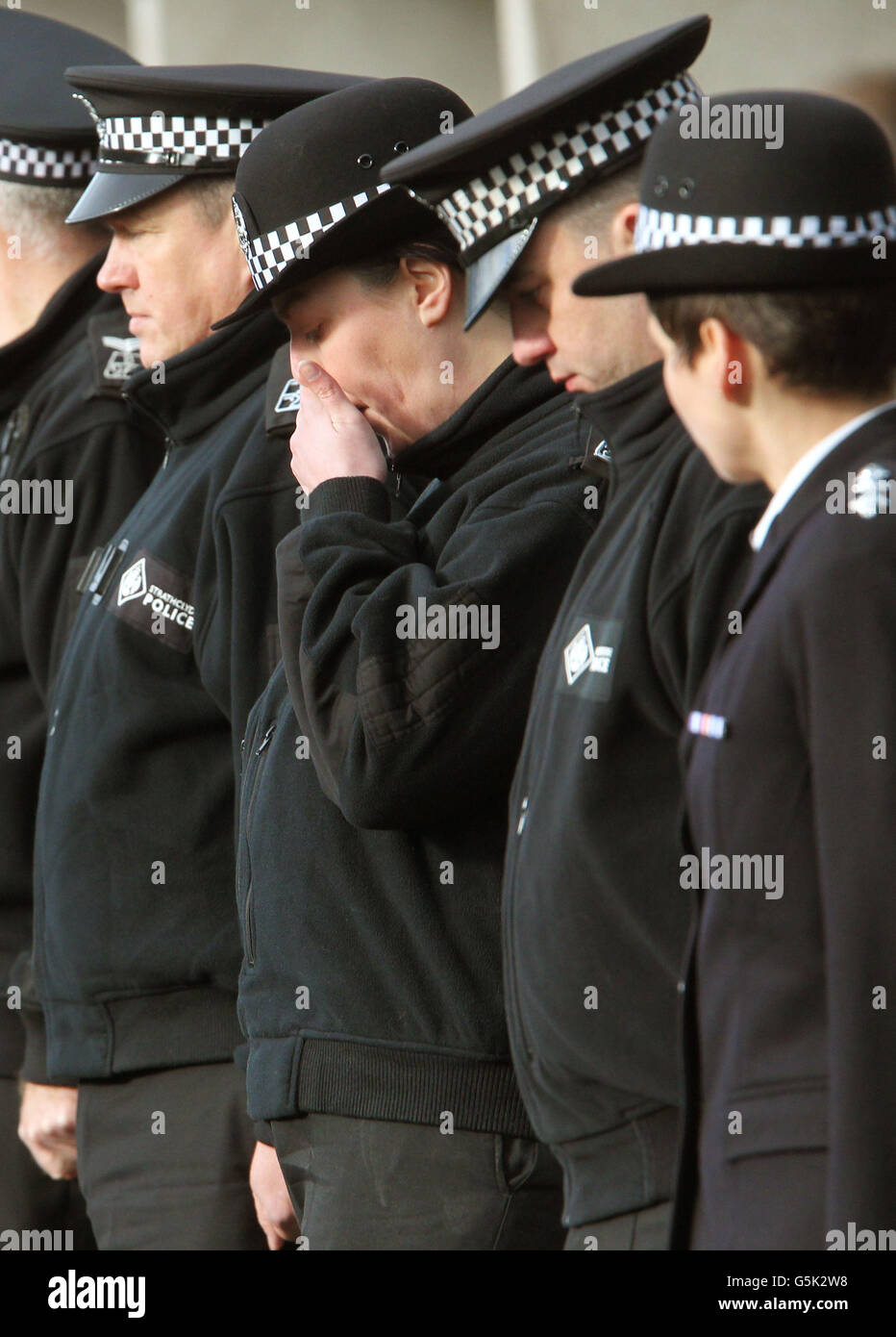 Police officers line up to show their respect as the cortege carrying ...