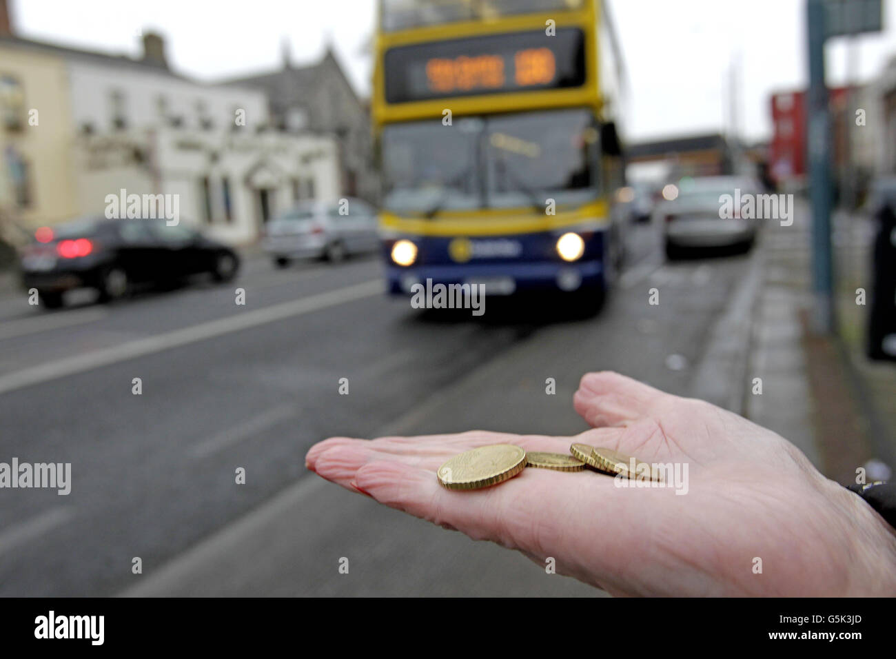 A commuter holds change to purchase a ticket on Dublin Bus at a bus ...