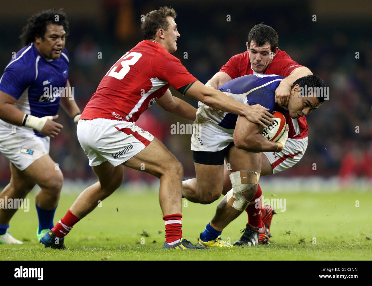Samoa's Maurie Fa'asavalu is tackled by Wales' Aaron Jarvis and Ashley ...
