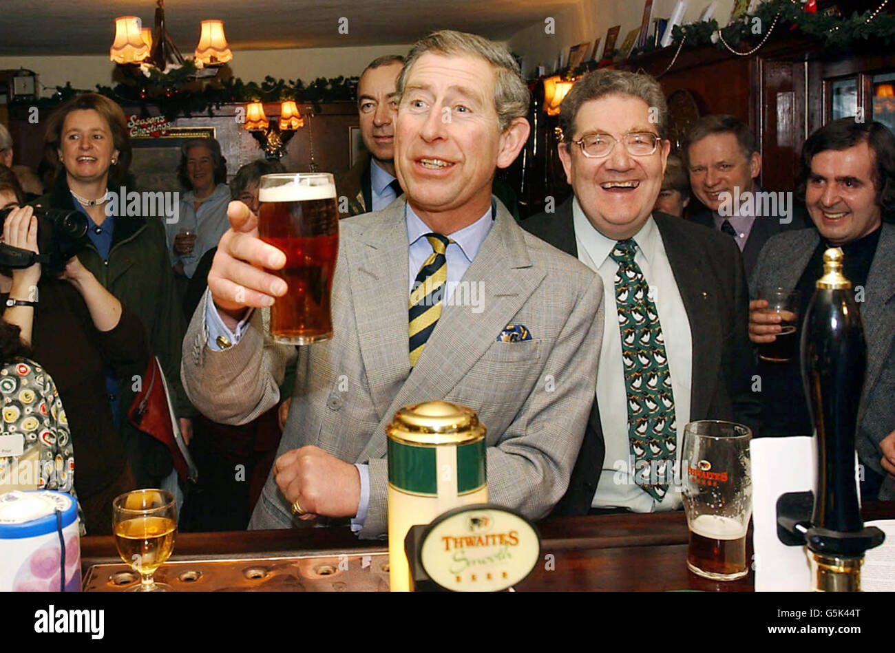 The Prince of Wales, raises a glass as he samples a pint of beer during ...