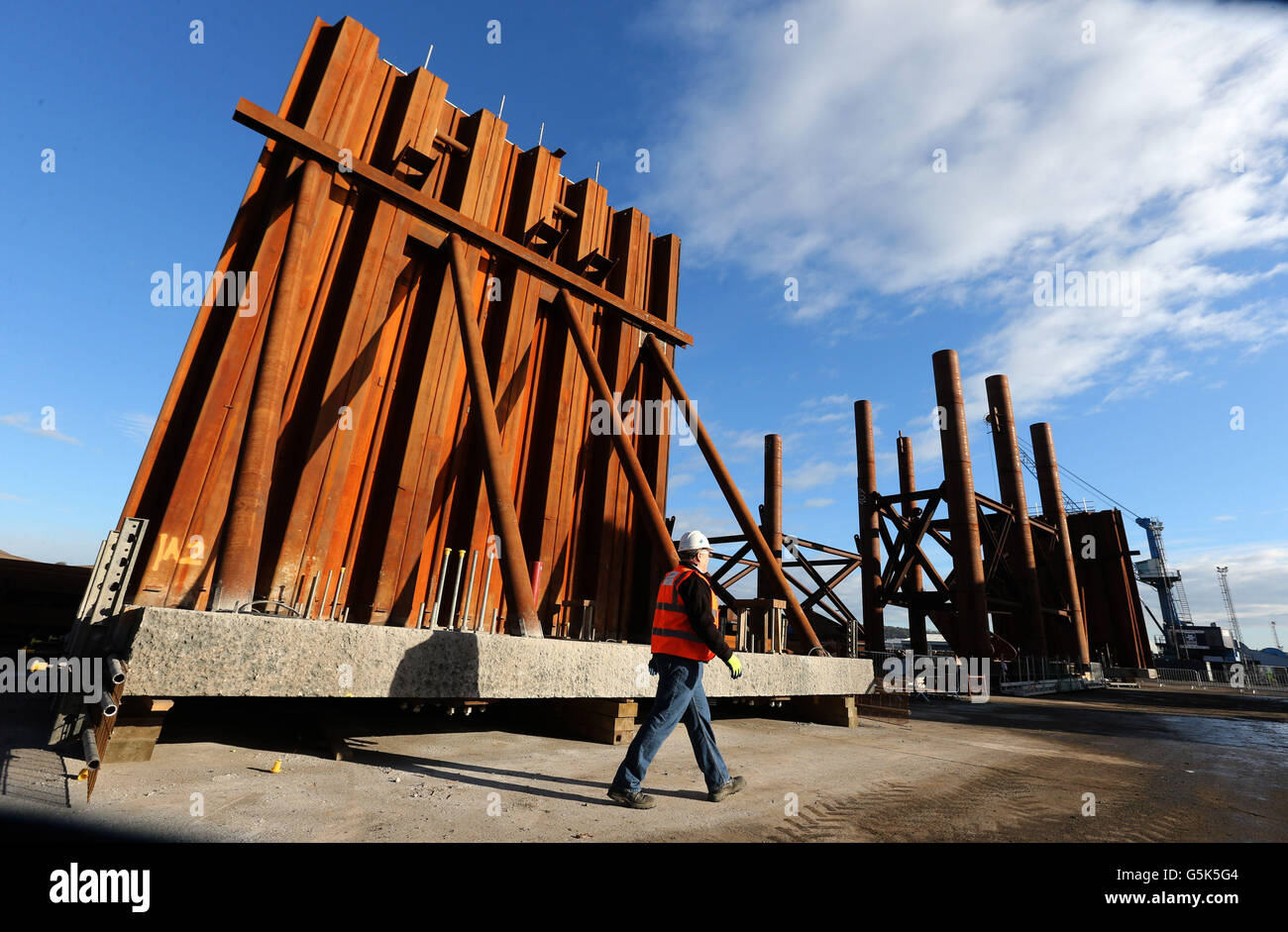 A workmen walks past an 'L' shaped structure similar to structures ...