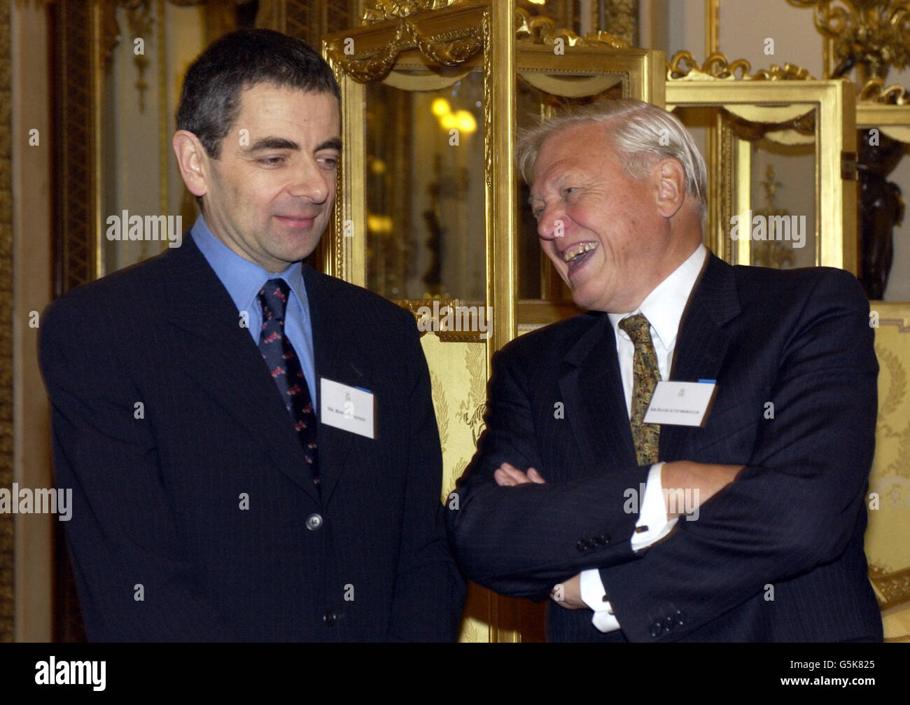 Natural History TV presenter Sir David Attenborough (R), shares a joke ...