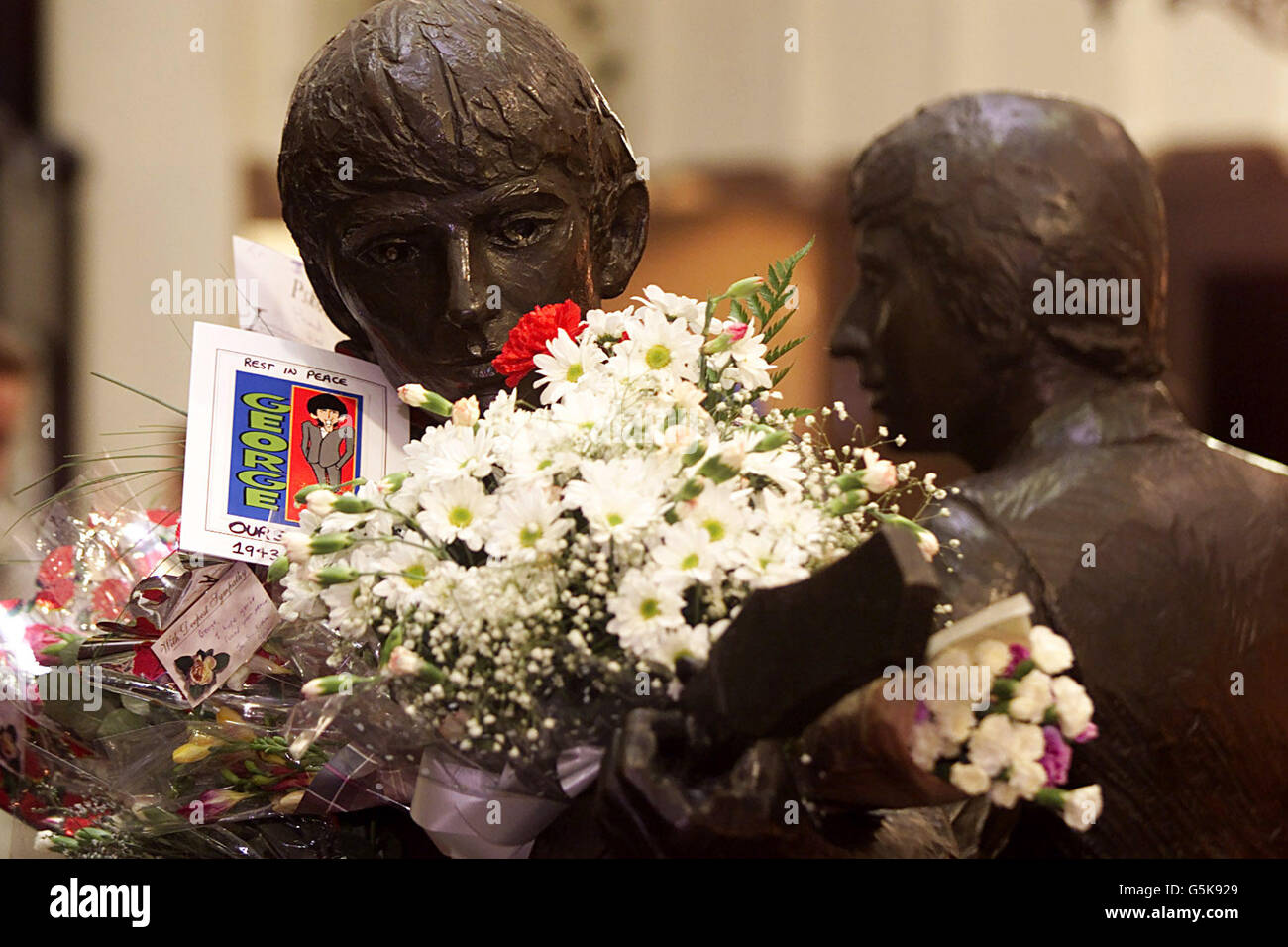 Flowers to remember George Harrison placed on his figure in the Beatles ...