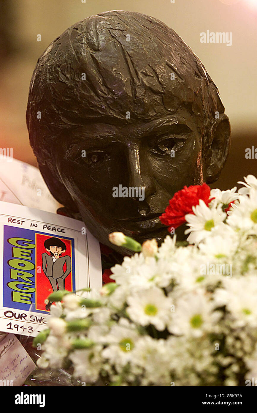 Flowers to remember George Harrison placed on his figure in the Beatles ...