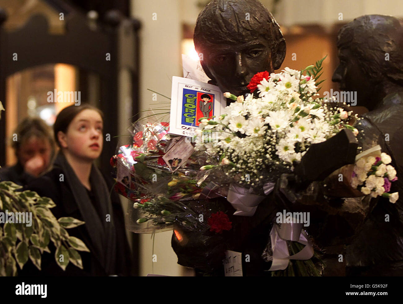 Flowers to remember George Harrison placed on his figure in the Beatles ...