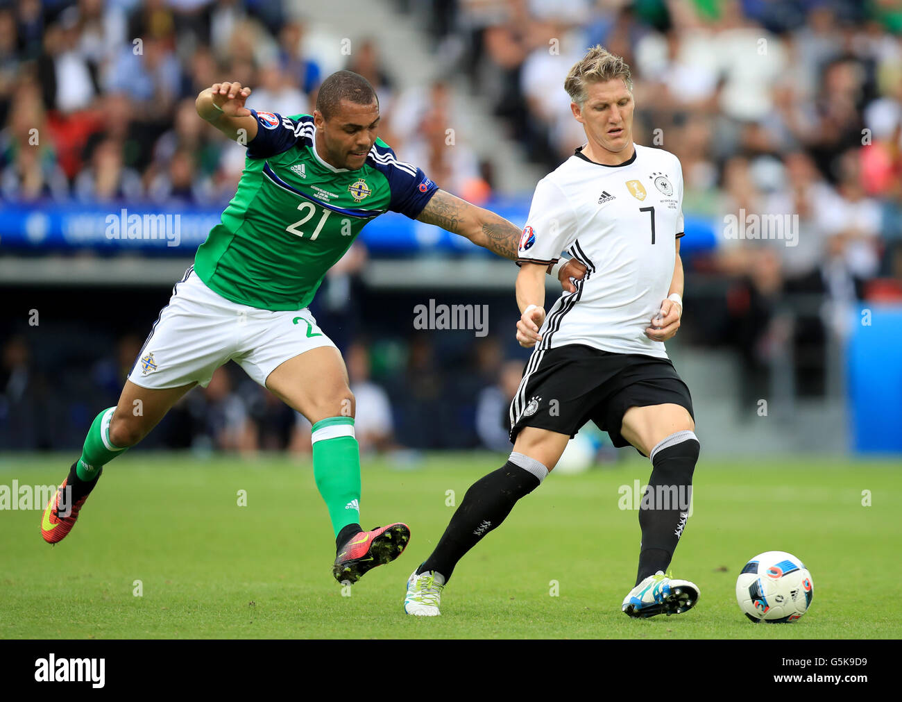 Northern Ireland's Josh Magennis (left) and Germany's Bastian ...