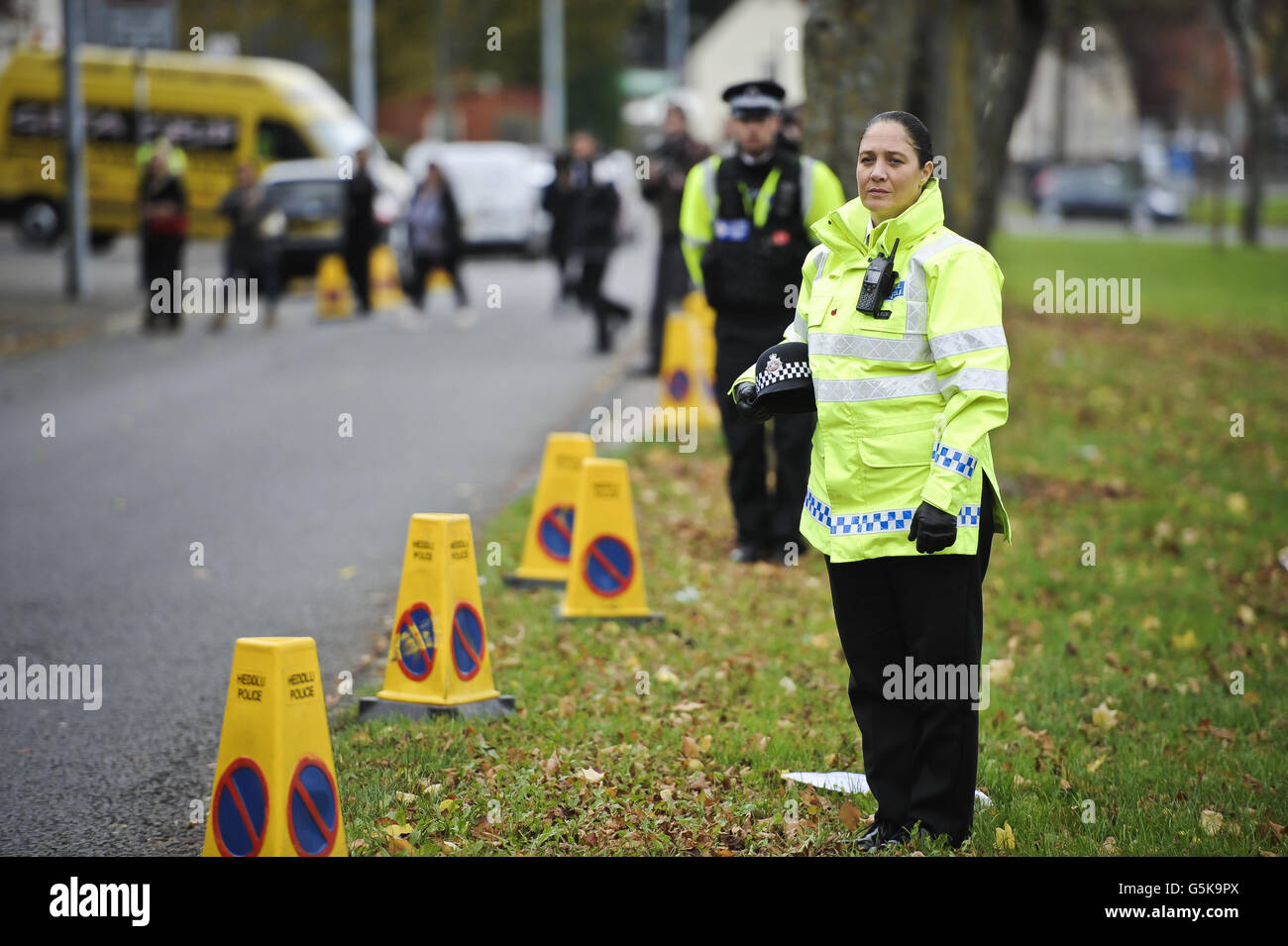 A police officer removes her hat as the leopard skin style coffin ...