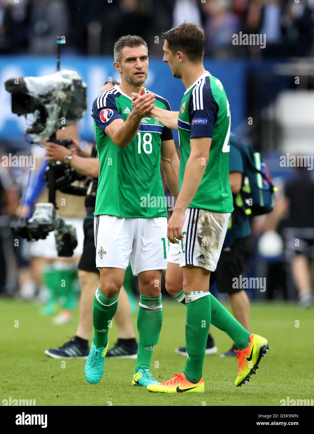 Northern Ireland's Aaron Hughes (left) consoles teammate Craig Cathcart ...