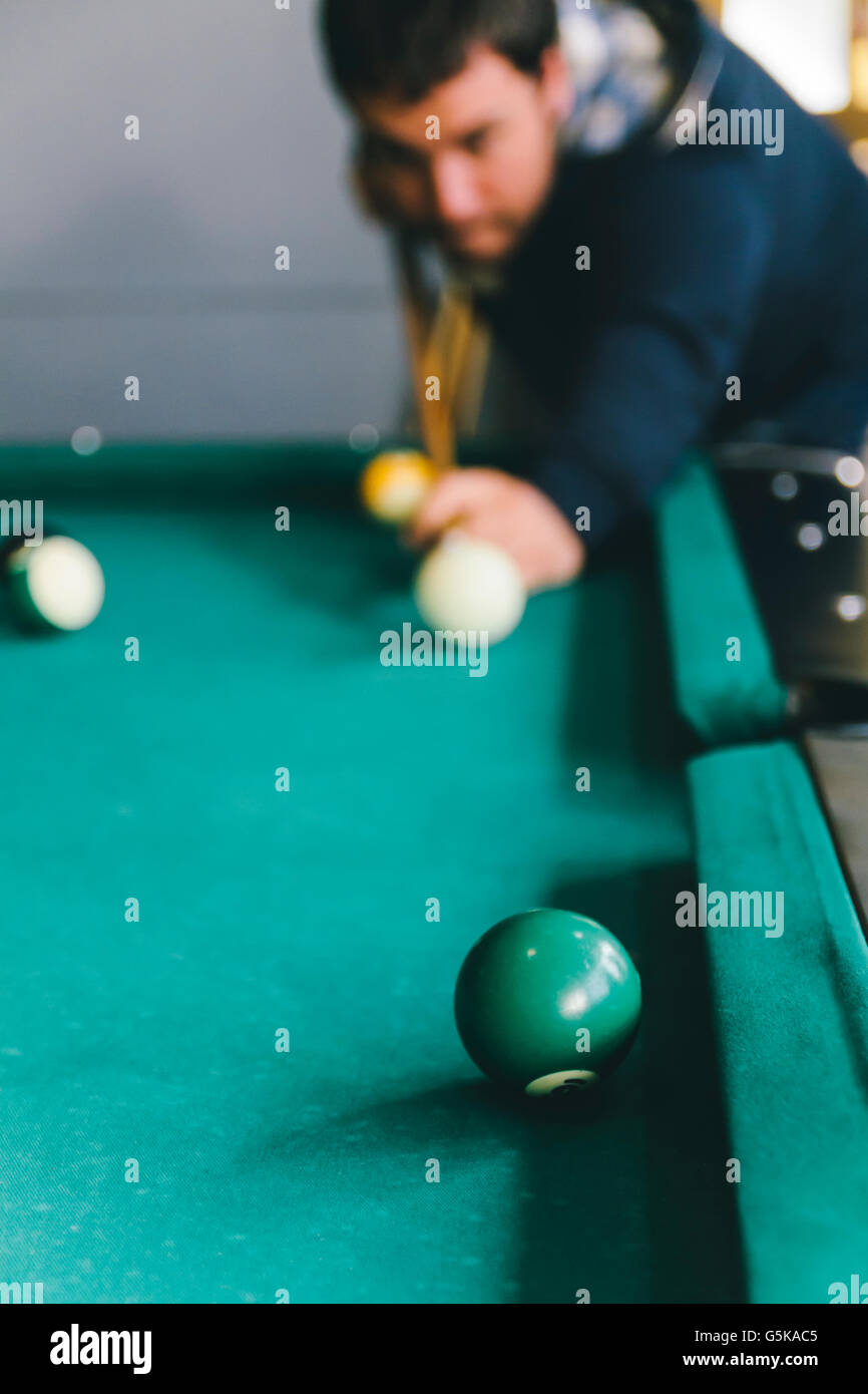 Hispanic man playing pool Stock Photo - Alamy