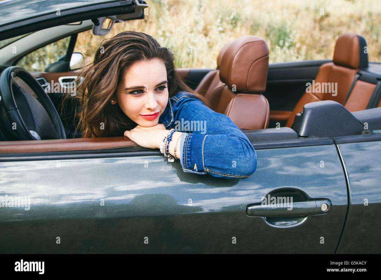Caucasian woman sitting in convertible Stock Photo - Alamy