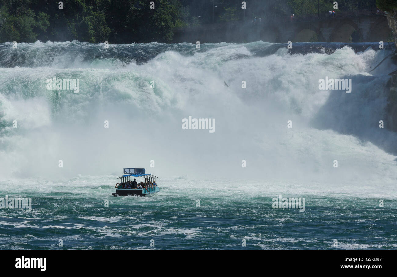 Boat floating near dramatic waterfall Stock Photo - Alamy