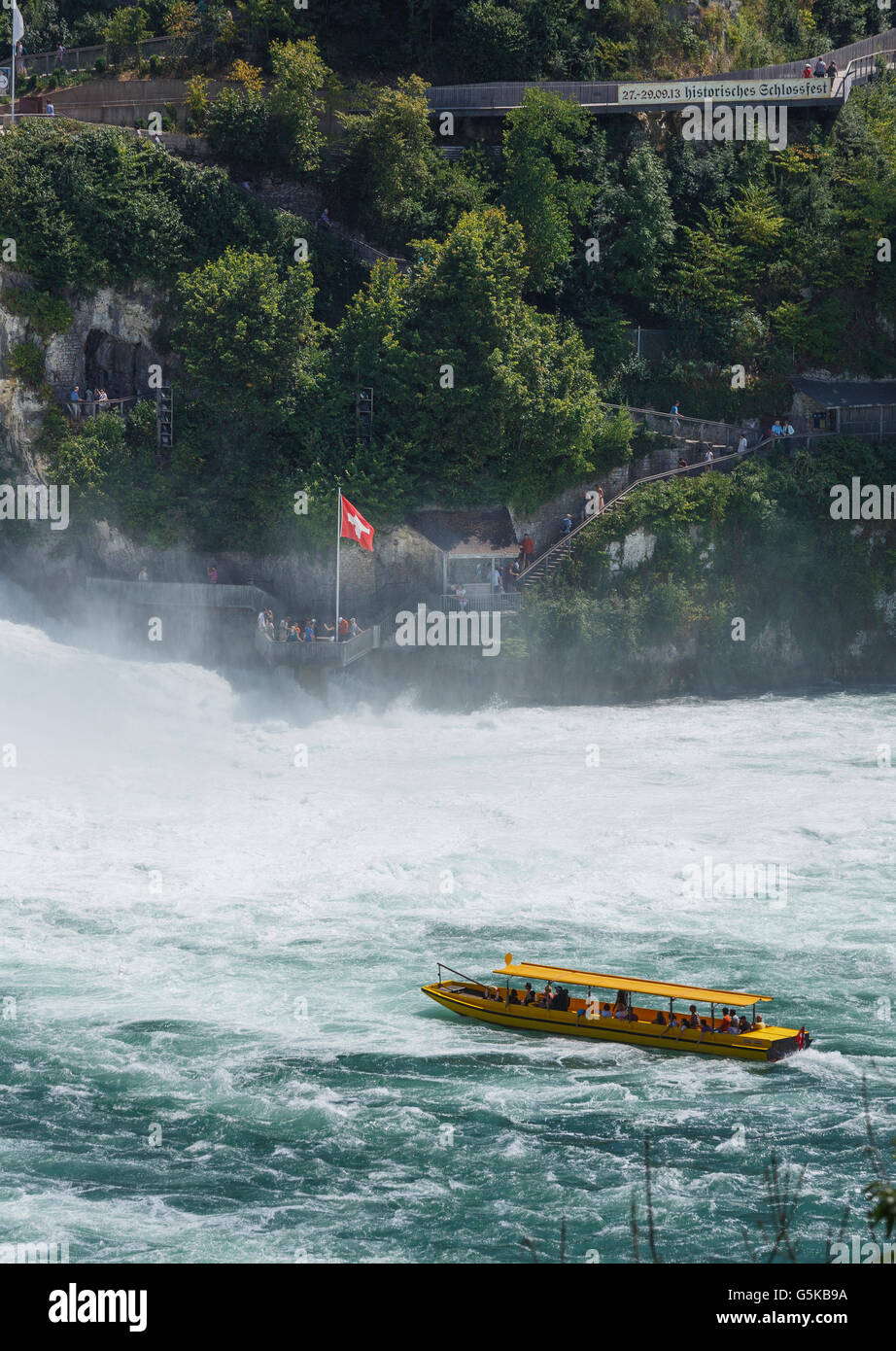 Boat floating near dramatic waterfall Stock Photo - Alamy