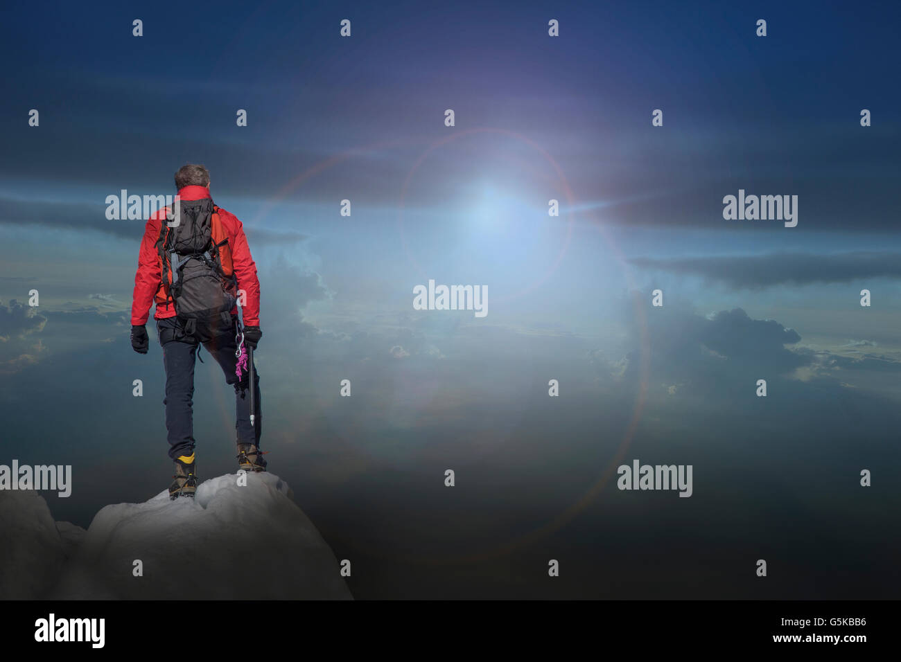 Caucasian hiker standing on mountain top Stock Photo - Alamy