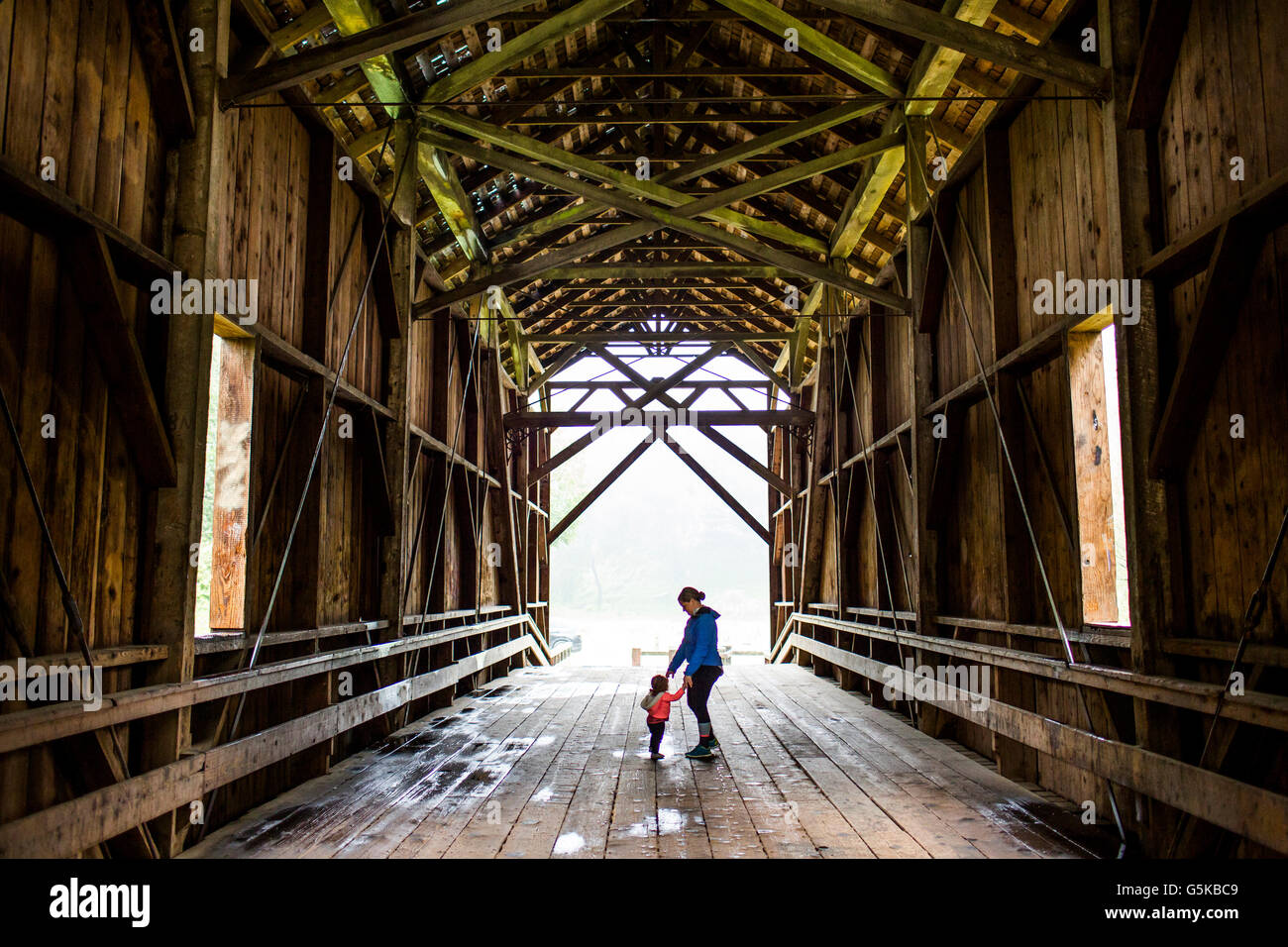 Caucasian mother and baby daughter on covered bridge Stock Photo - Alamy