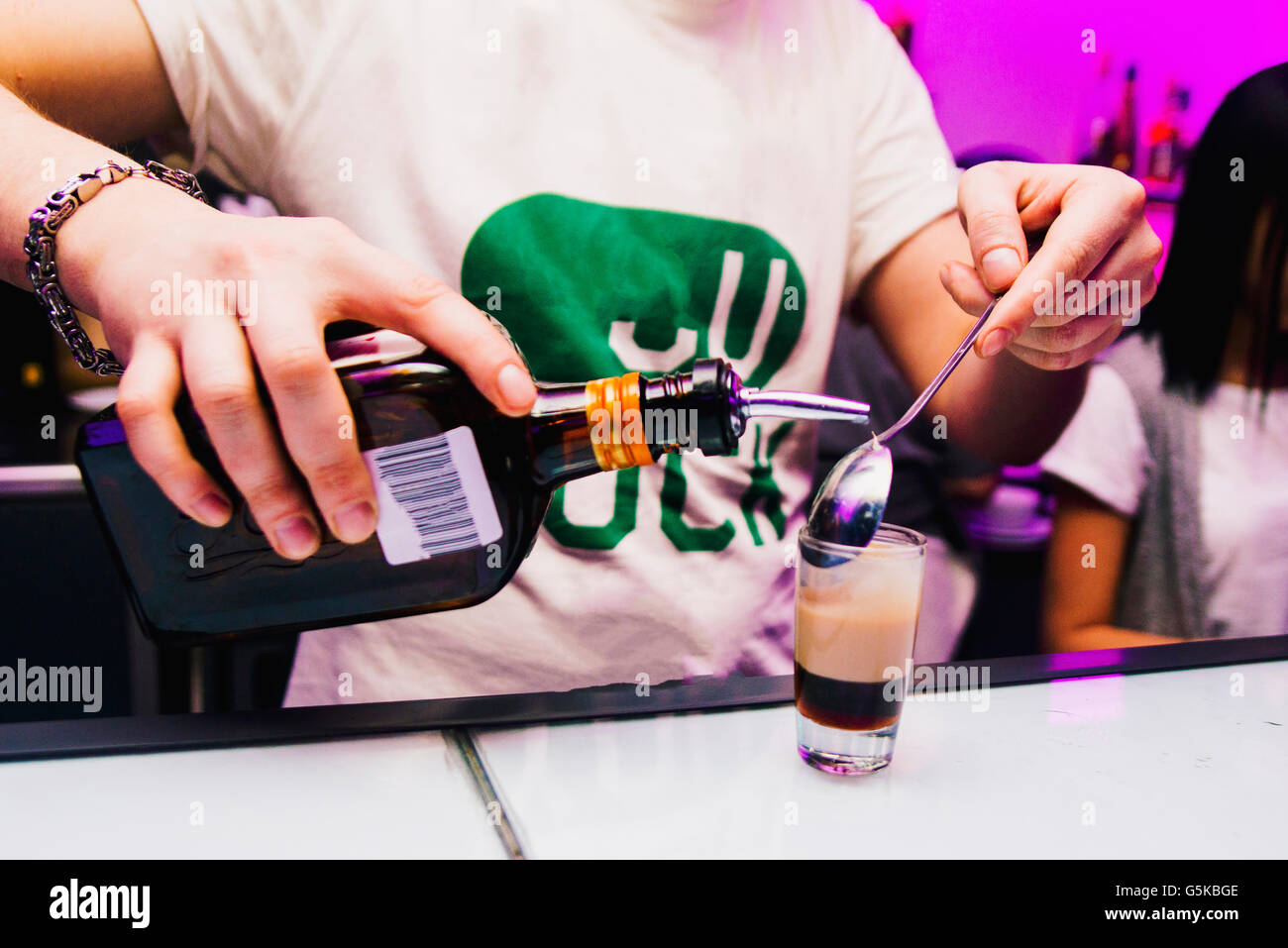 Bartender pouring shot in nightclub Stock Photo - Alamy