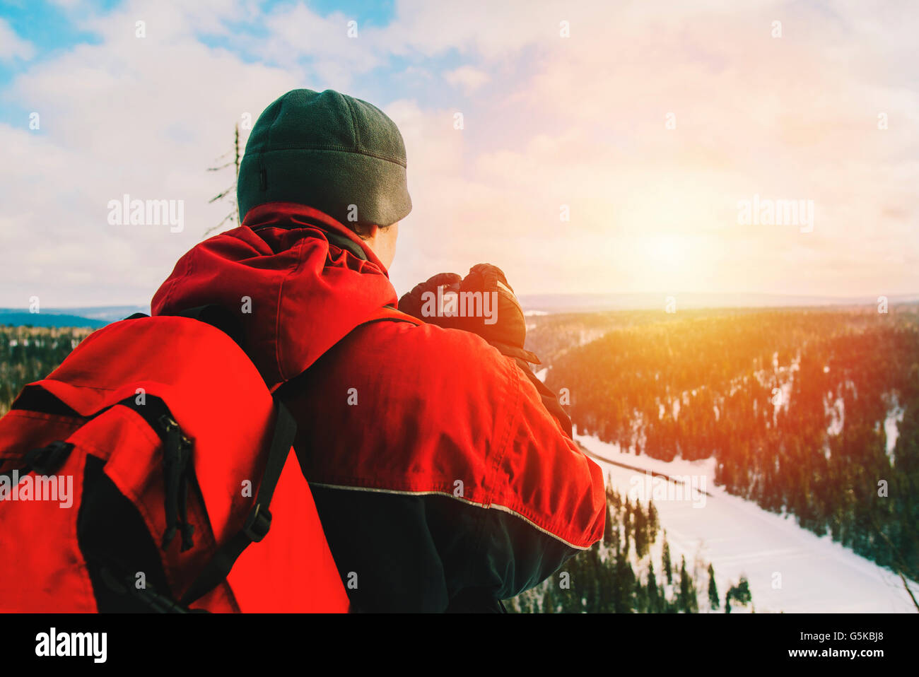 Hiker photographing remote landscape from mountain Stock Photo - Alamy