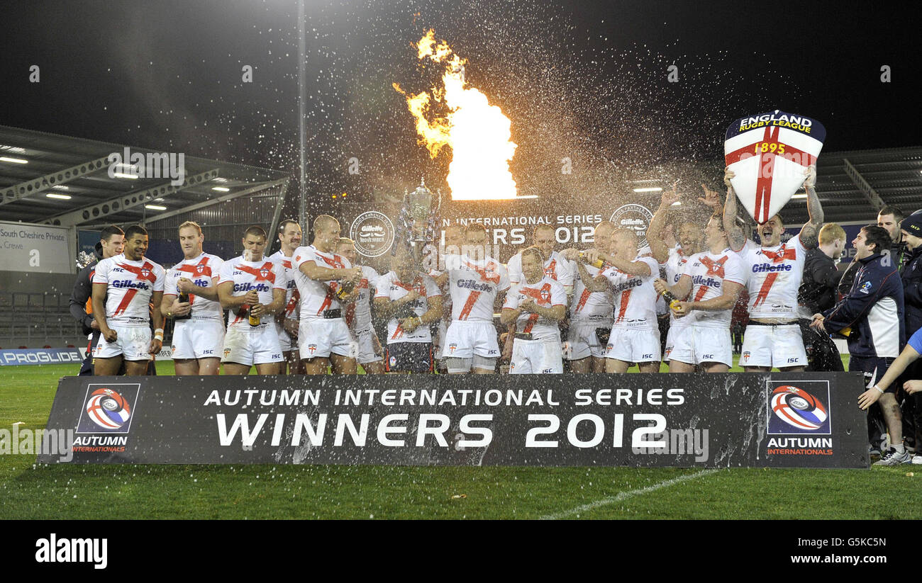 The England team celebrate their victory with the trophy following the ...