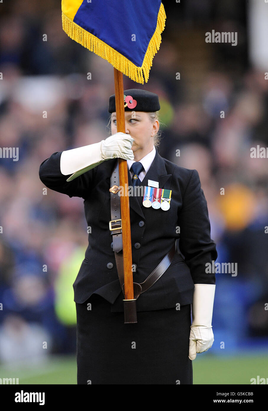 An armed forces representative on the pitch as part of the remembrance ...