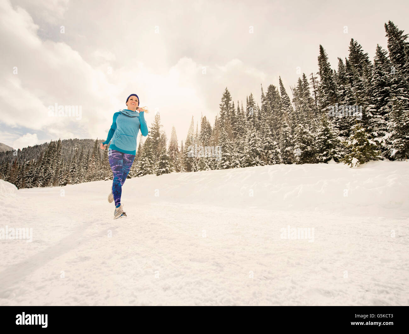 Woman run snow low angle hi-res stock photography and images - Alamy