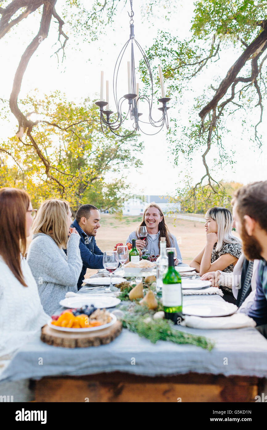 Friends drinking wine at outdoor table Stock Photo - Alamy