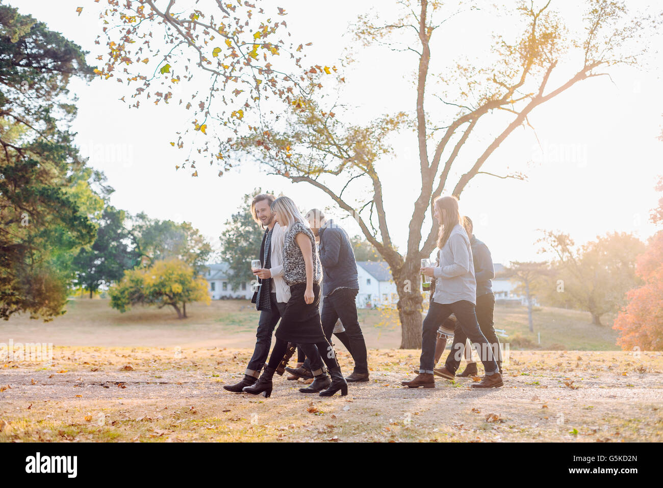 Friends walking in rural field Stock Photo - Alamy