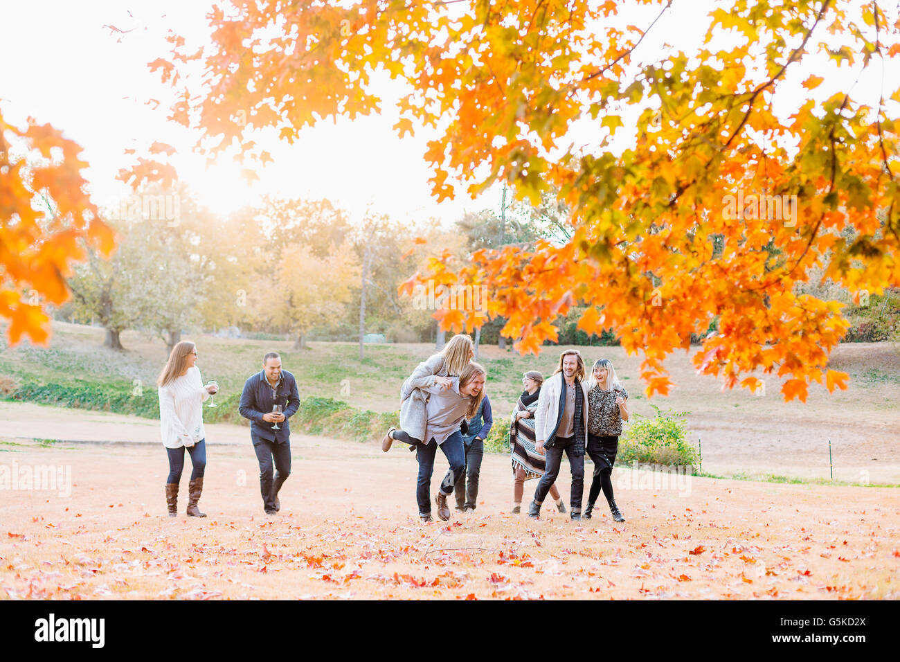 Friends walking in rural field Stock Photo - Alamy
