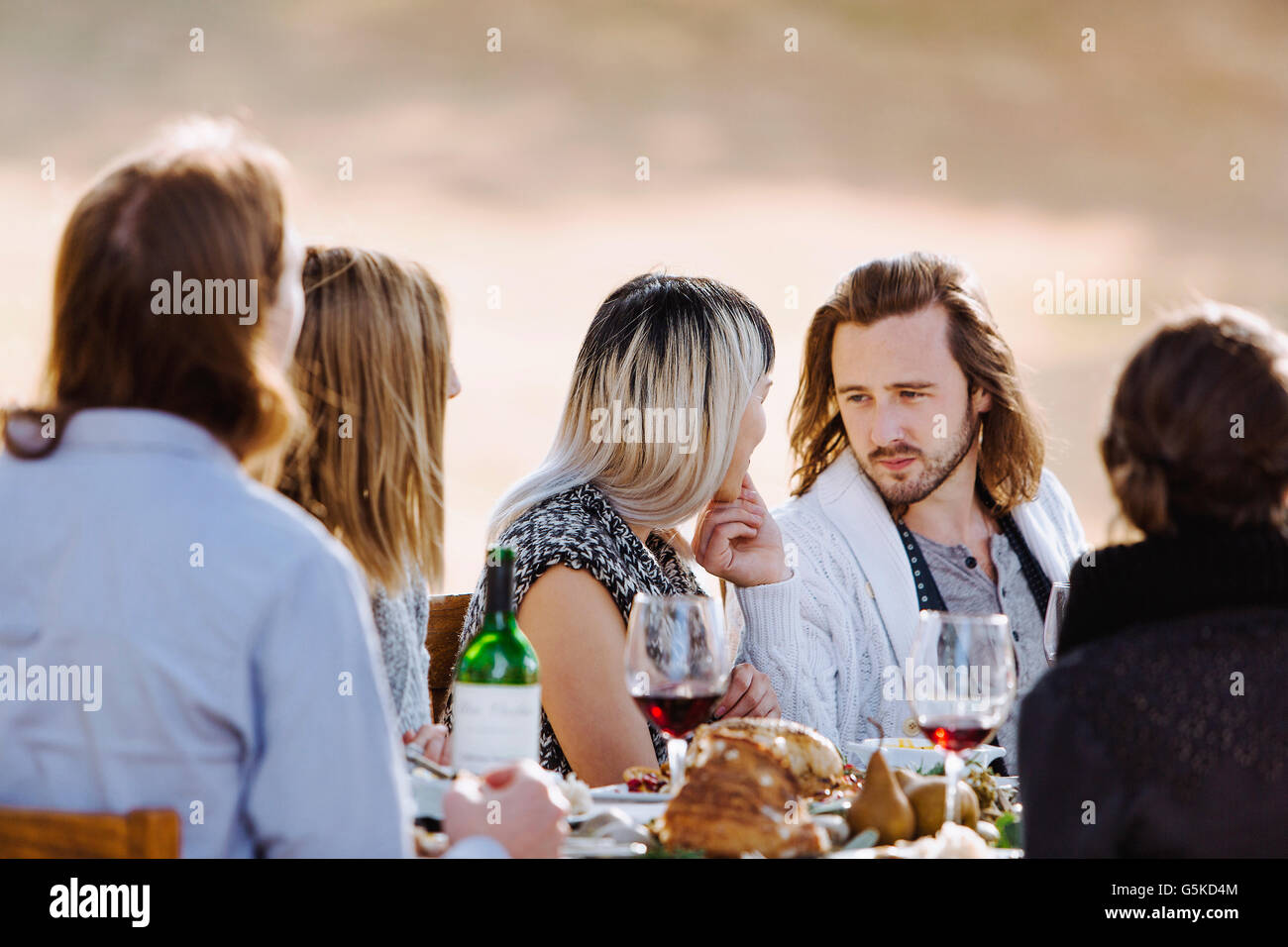 Friends eating at outdoor table Stock Photo - Alamy
