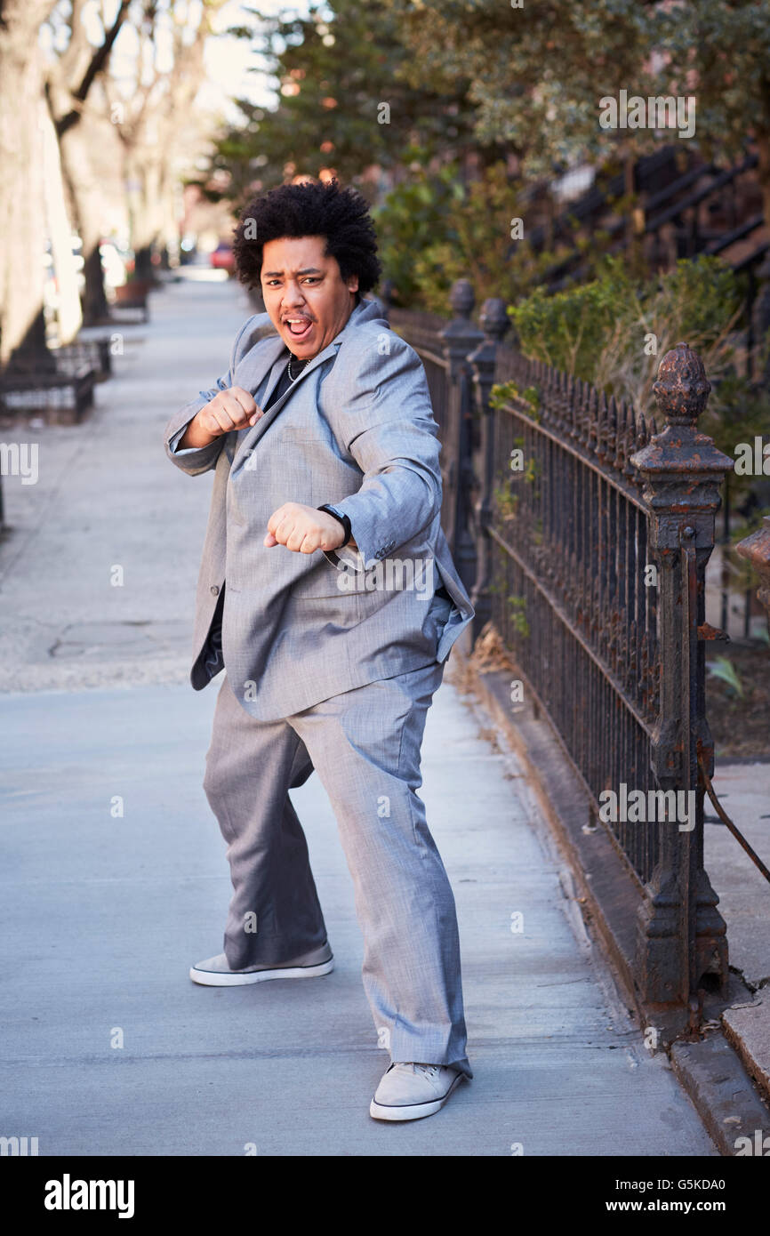 Mixed race man in defensive pose on sidewalk Stock Photo - Alamy
