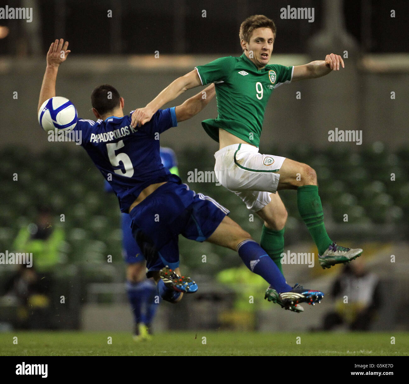 Ireland's Kevin Doyle and Greece's Kyriakos Papadopoulos (left) battle ...