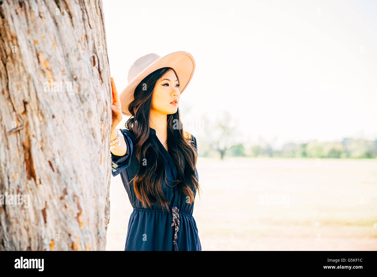 Chinese woman standing in field Stock Photo - Alamy