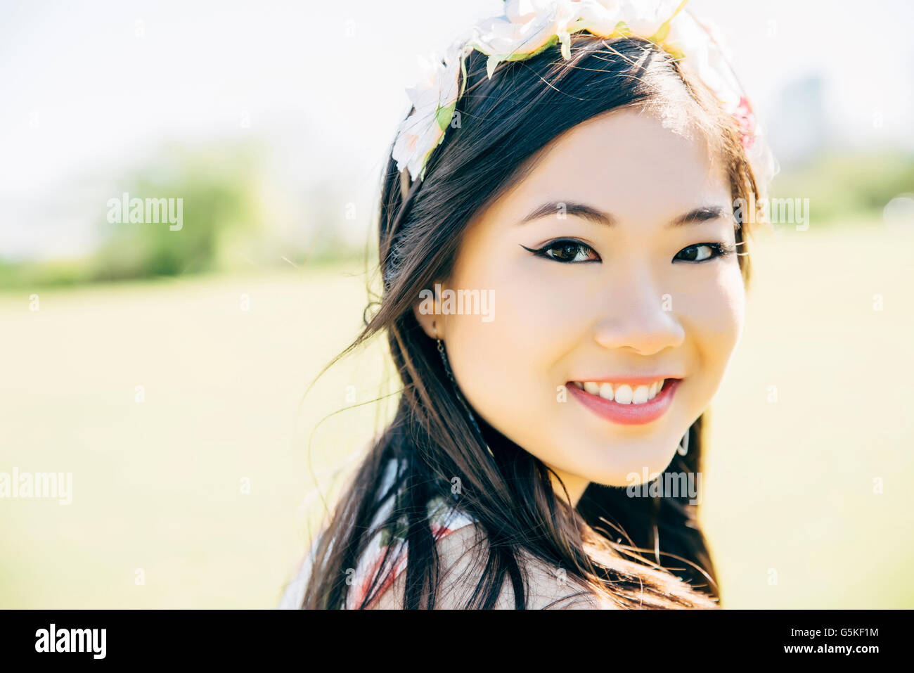 Chinese woman smiling outdoors Stock Photo - Alamy